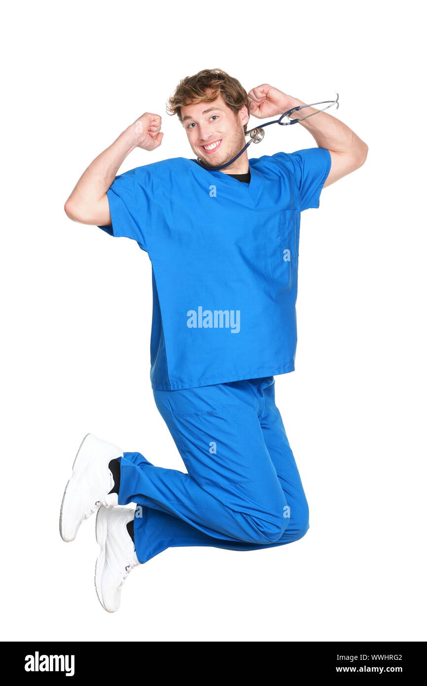 happy male nurse or doctor jumping in blue scrubs smiling excited ...