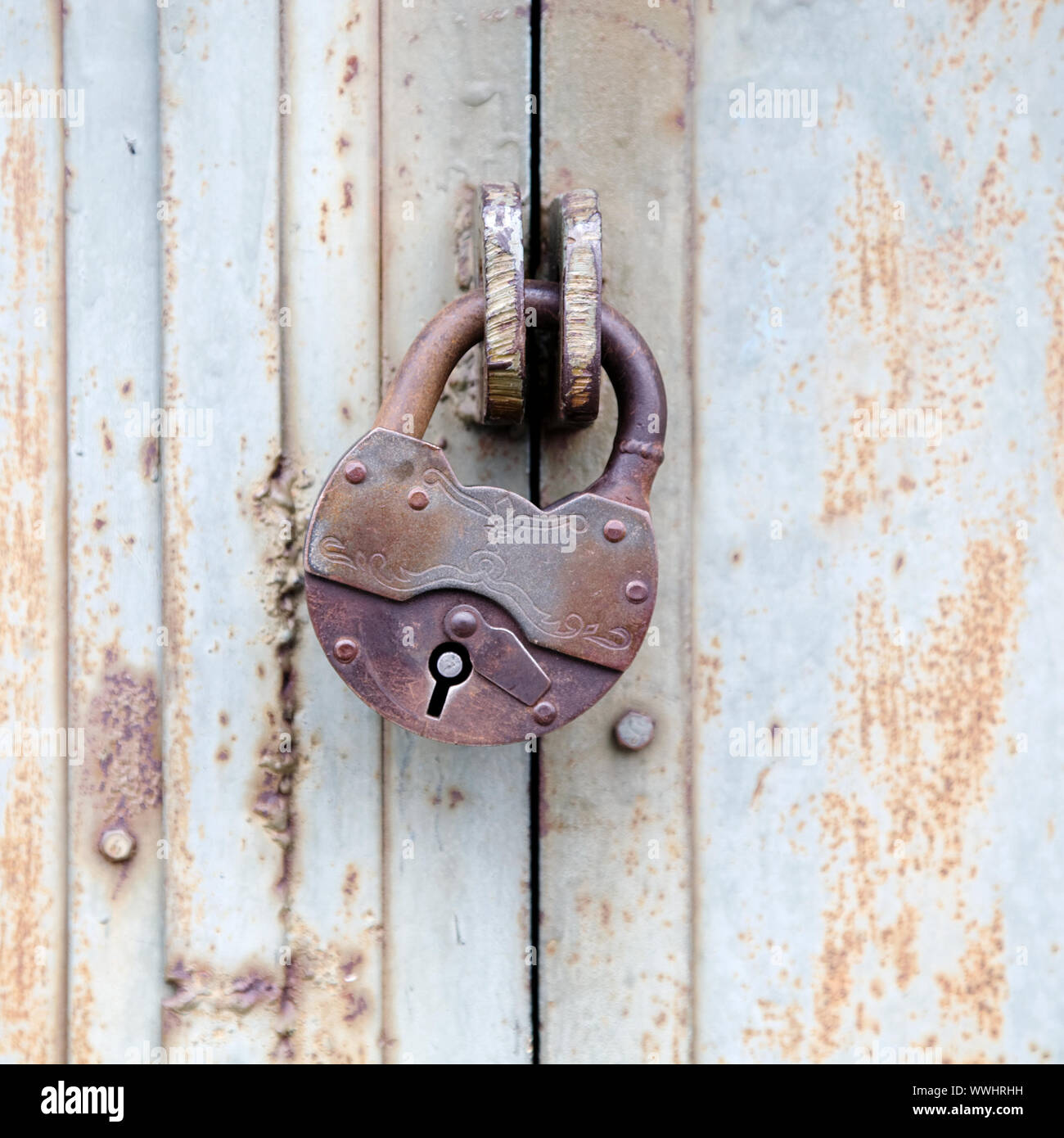 Rusty old padlock on a metal fence Stock Photo - Alamy