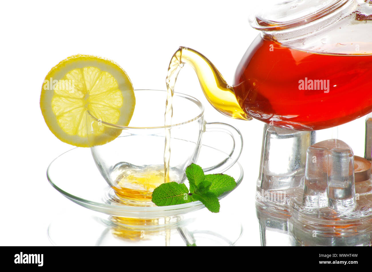 Tea being poured into glass tea cup Stock Photo - Alamy