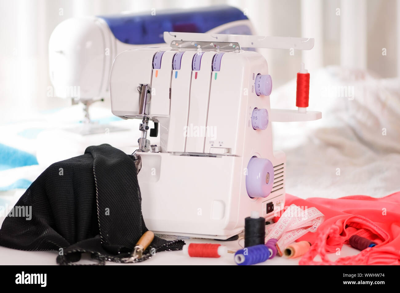 overlock and sewing machine is on the table Stock Photo - Alamy