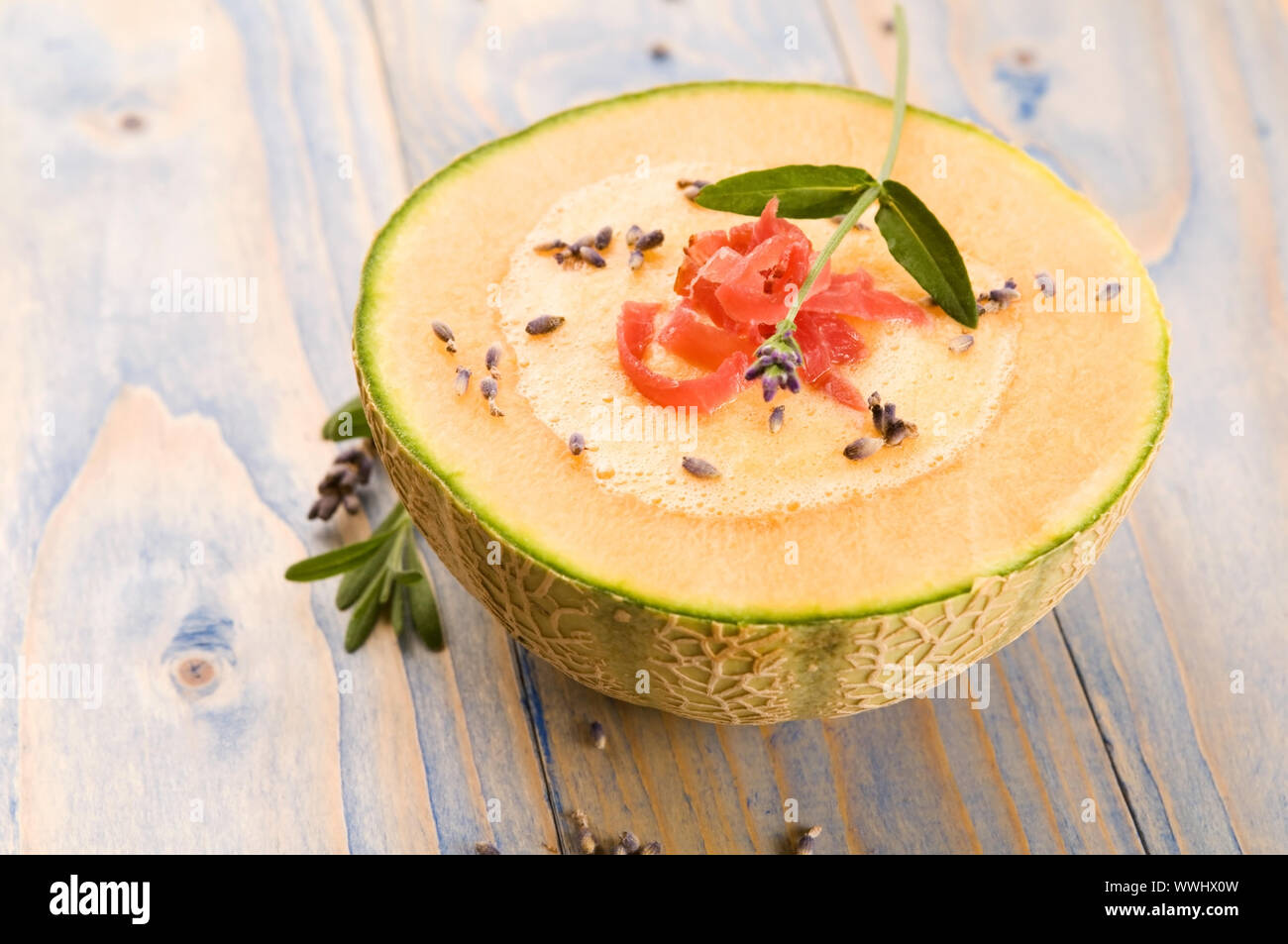 fresh melon soup with parma ham and lavender flower Stock Photo - Alamy