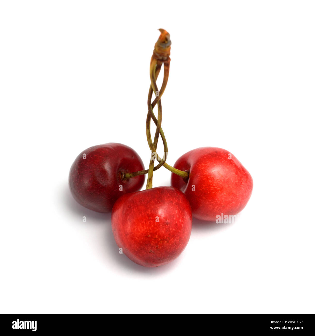 Three berries of a sweet cherry on a white background Stock Photo - Alamy