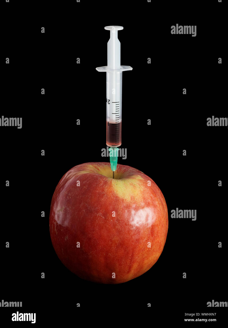 Apple with the thrust needle of a syringe in a soft flesh Stock Photo ...