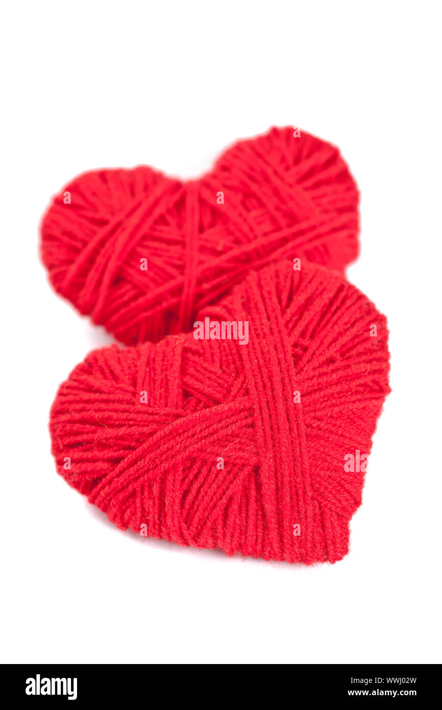 two red thread hearts isolated on white background Stock Photo - Alamy