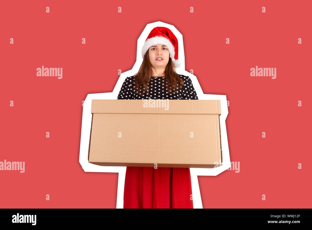 Portrait of excited surprised girl in dress holding big and heavy gift ...