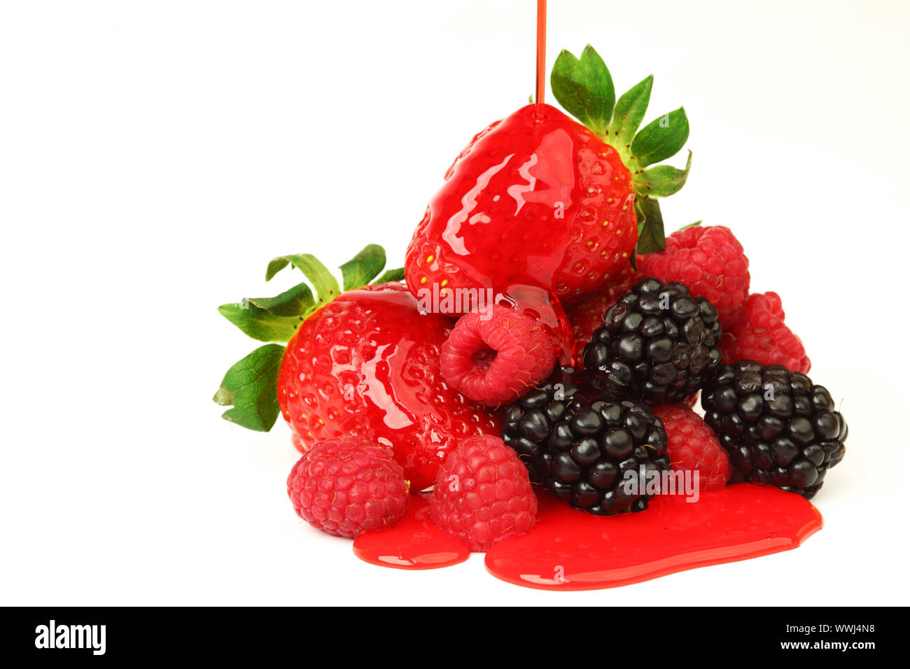 big berry pile in syrup isolated on white Stock Photo - Alamy
