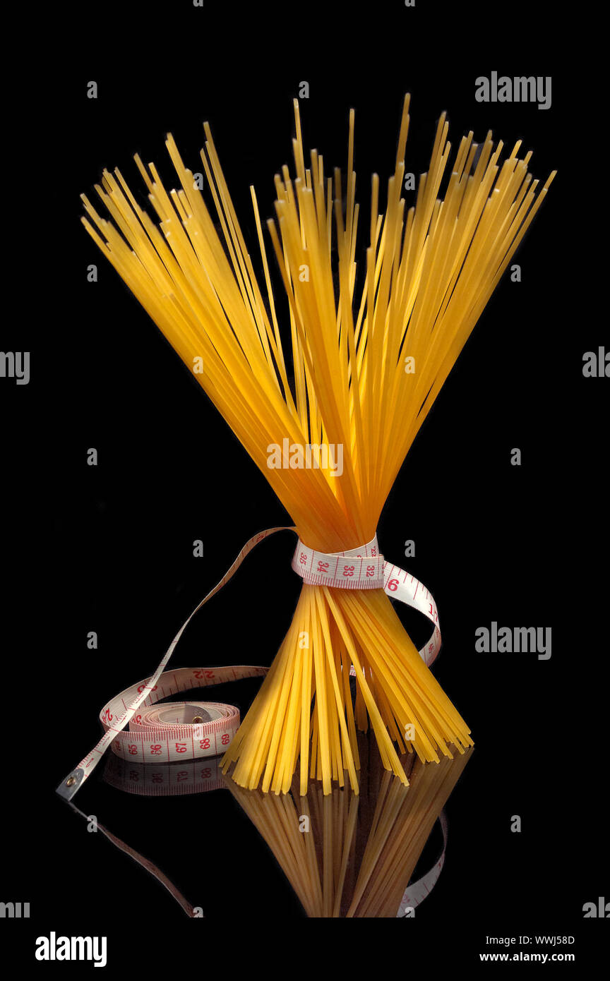 Italian spaghetti pastawith tape meter over black closeup Stock Photo ...
