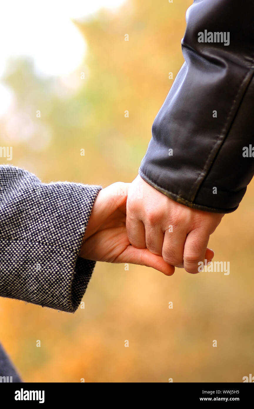 Hand-in-hand. Couple love in autumn scenery Stock Photo - Alamy