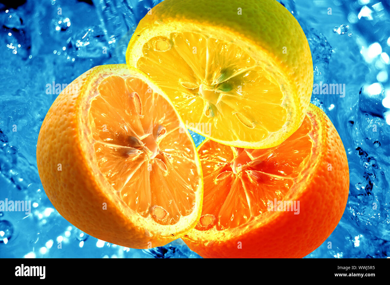 Fresh halves of citrus fruits on water background Stock Photo - Alamy