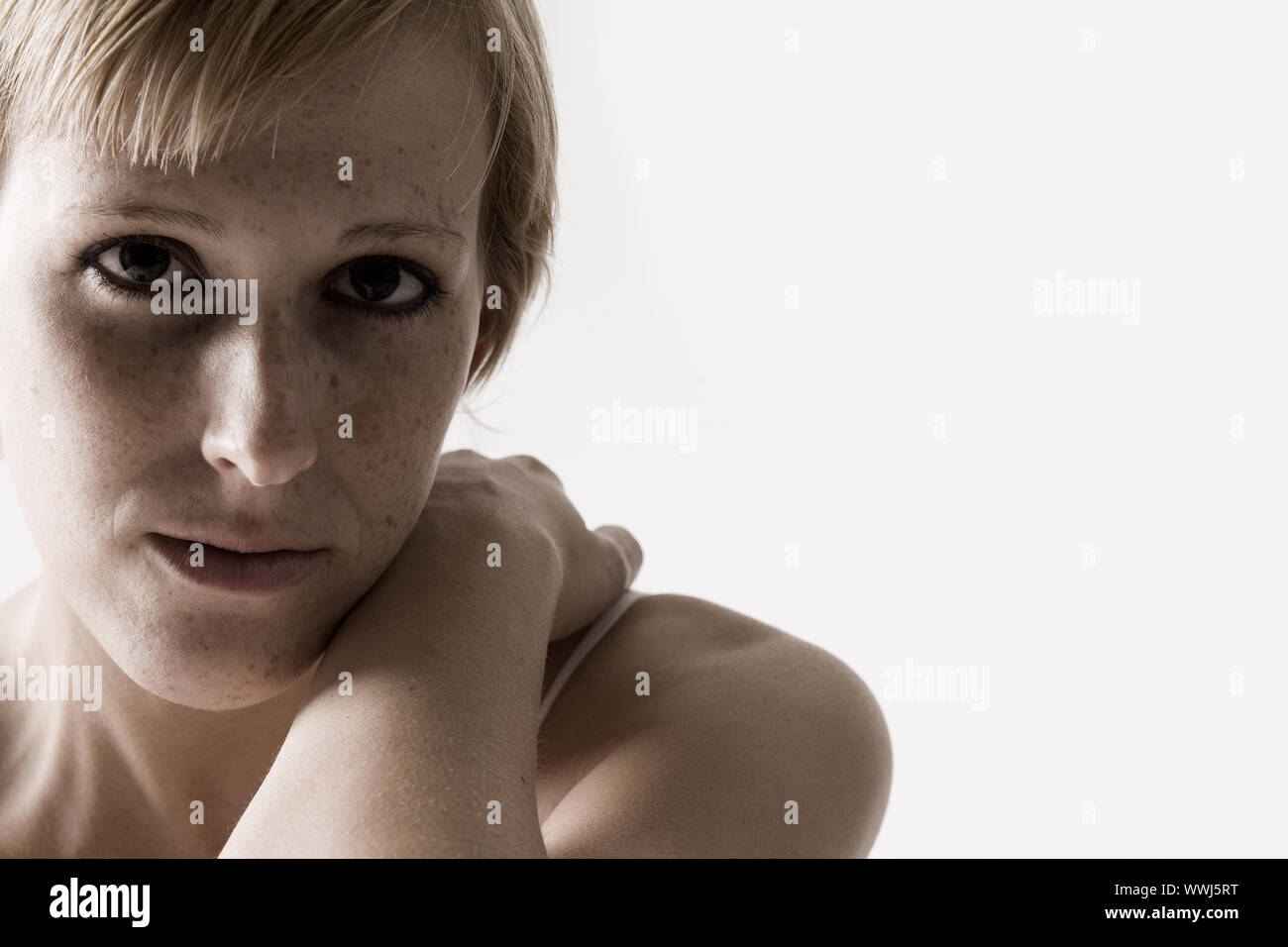 Studio portrait of a blond short haired girl looking sad Stock Photo ...