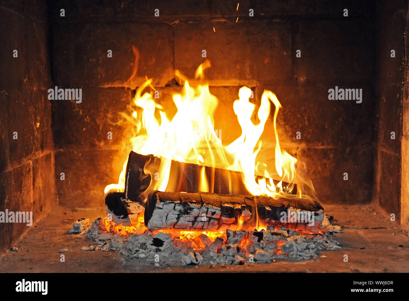 Wood fire in an open fireplace Stock Photo - Alamy
