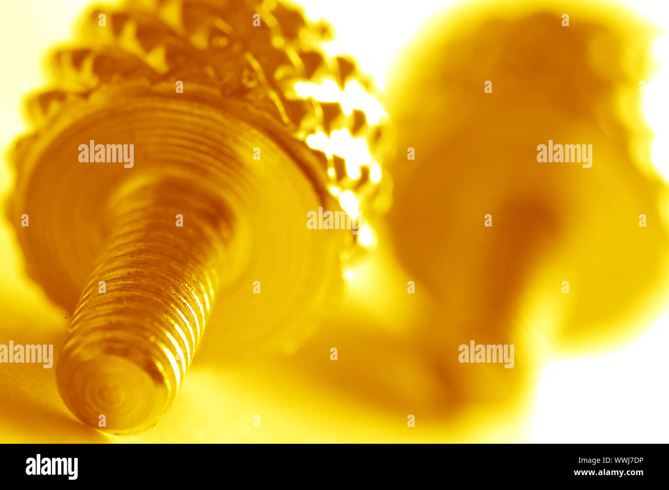 Yellow screw close-up. Conceptual image Stock Photo - Alamy
