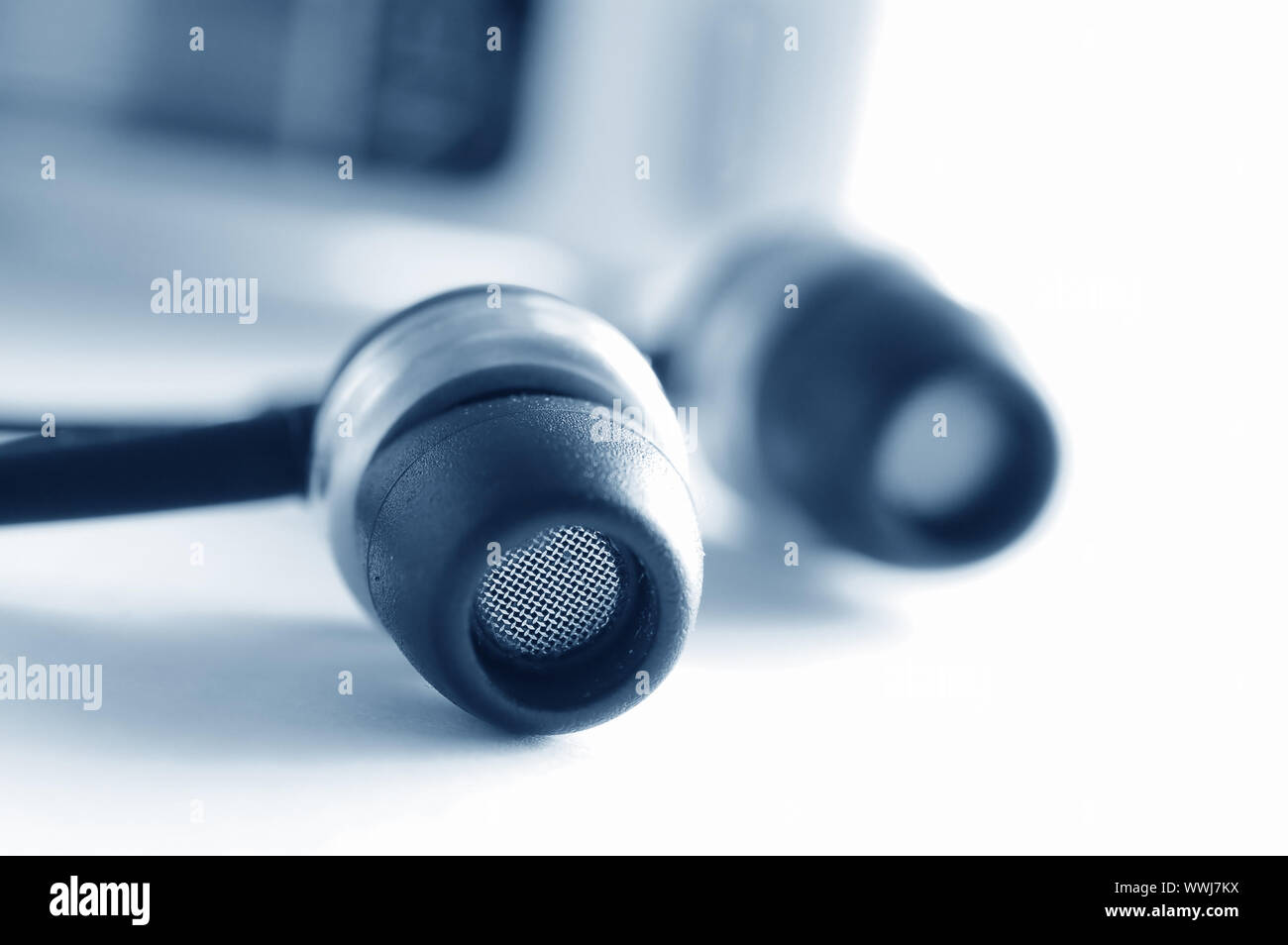 Modern headphones and music player in the background Stock Photo - Alamy