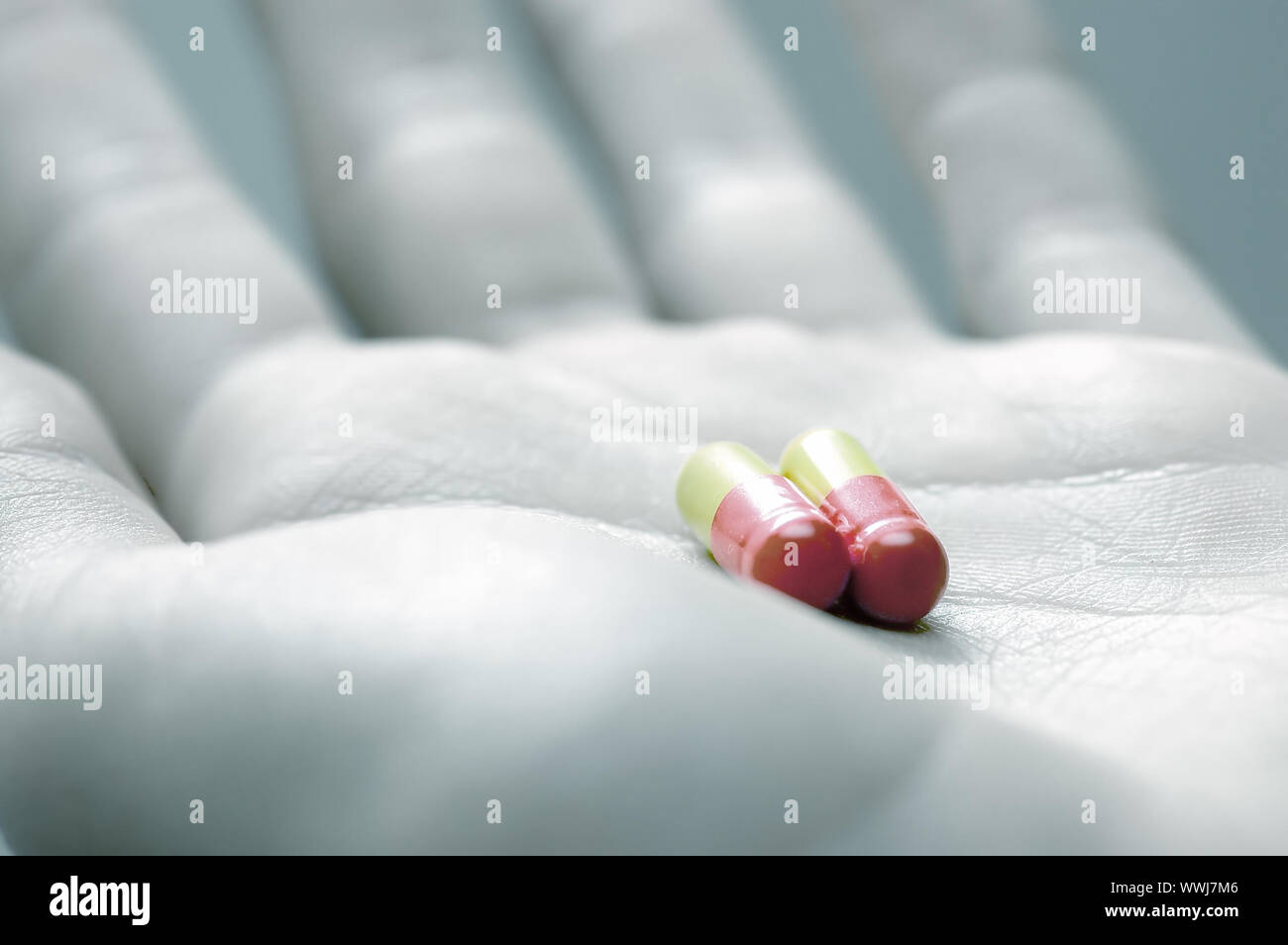 Taking pills. Hand with two capsules Stock Photo - Alamy