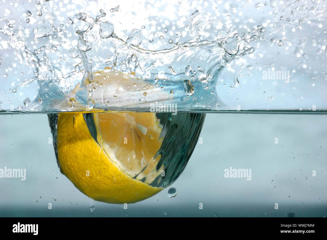Fresh lemon splash into water Stock Photo - Alamy
