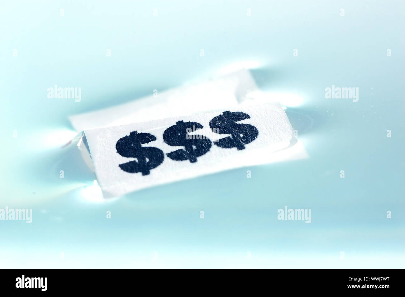 Card floating on water surface with printed: $$$ Stock Photo - Alamy