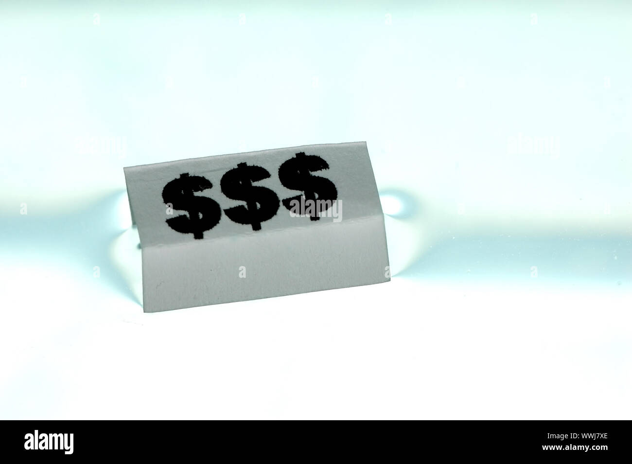 Card floating on water surface with printed: $$$ Stock Photo - Alamy