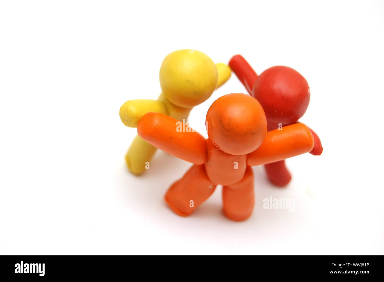 3 plasticine figures staying together and celebrating Stock Photo - Alamy