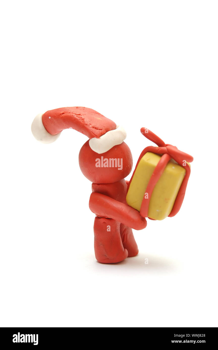 Plasticine Santa Claus holding big present Stock Photo - Alamy