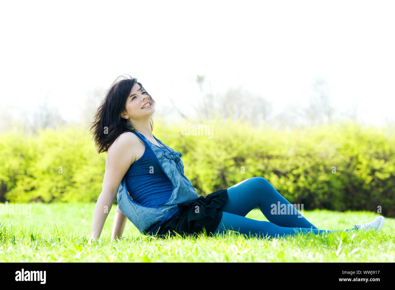 Young happy smiling girl lying on grass Stock Photo - Alamy