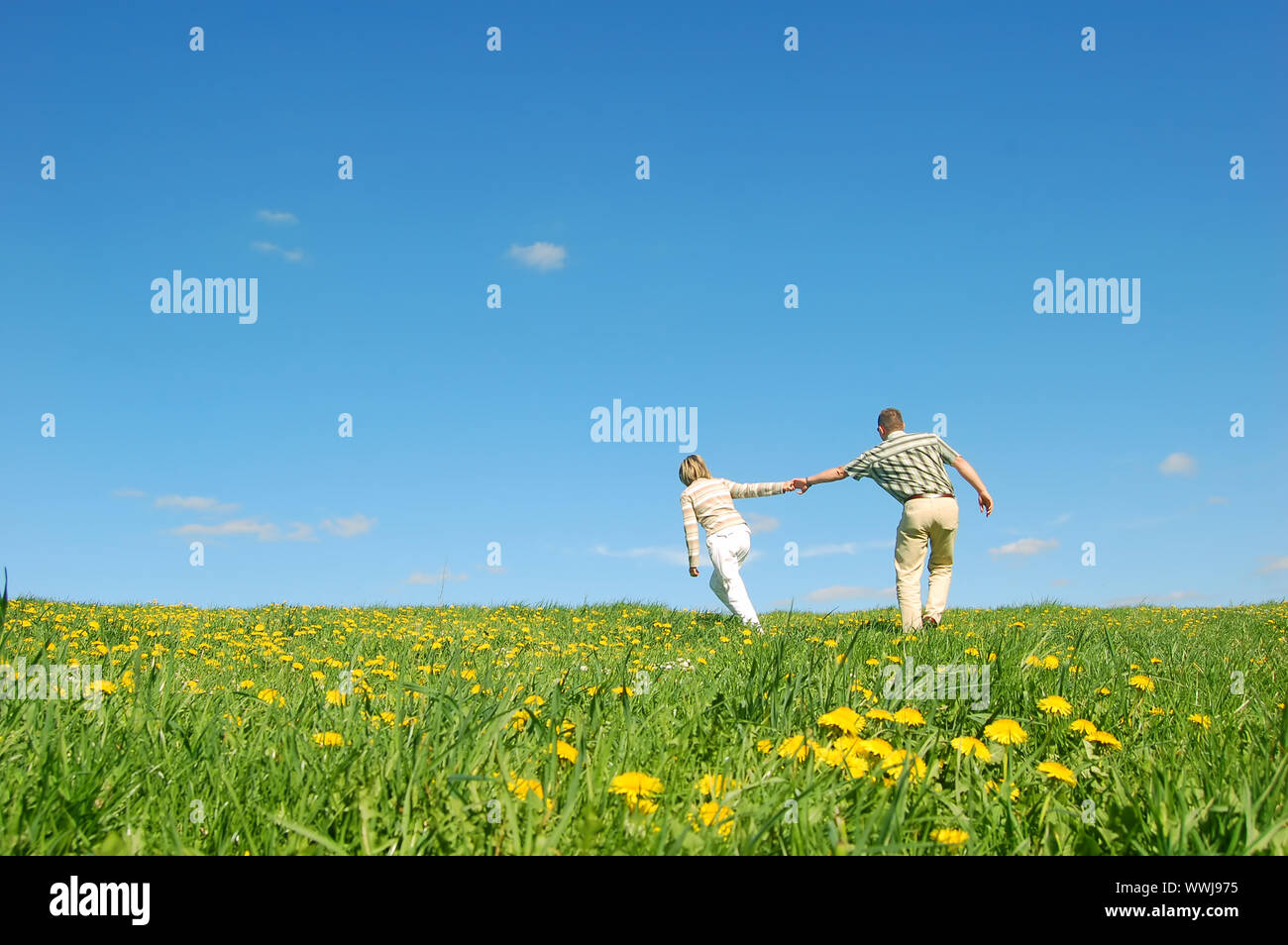 Couple in love having fun on spring meadow Stock Photo - Alamy