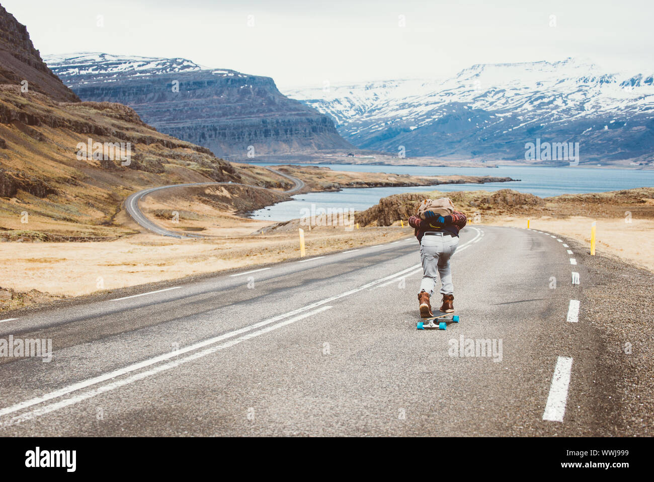 Skater traveling iceland on his longboard Stock Photo - Alamy