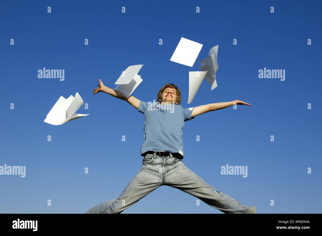 Happy boy throw up pieces of paper. The start of holiday Stock Photo ...
