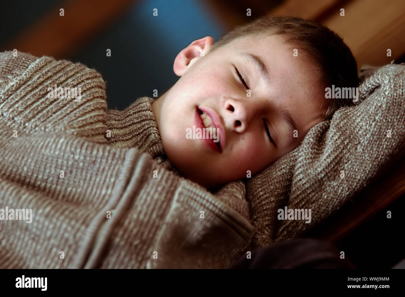 Sleepy boy. Tired falls asleep on stairs Stock Photo - Alamy
