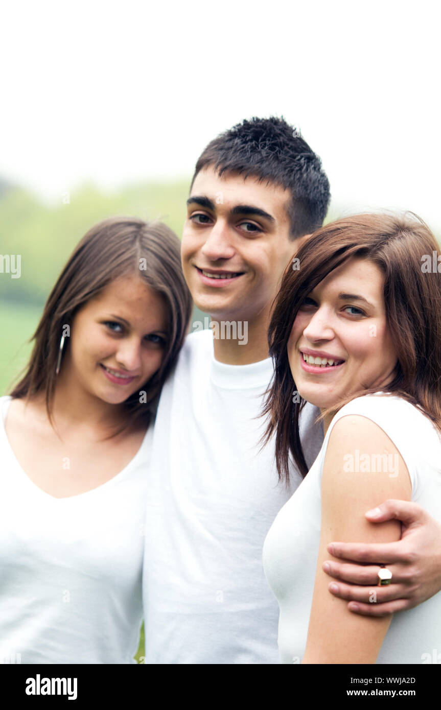 Three young happy friends standing together and smiling Stock Photo - Alamy