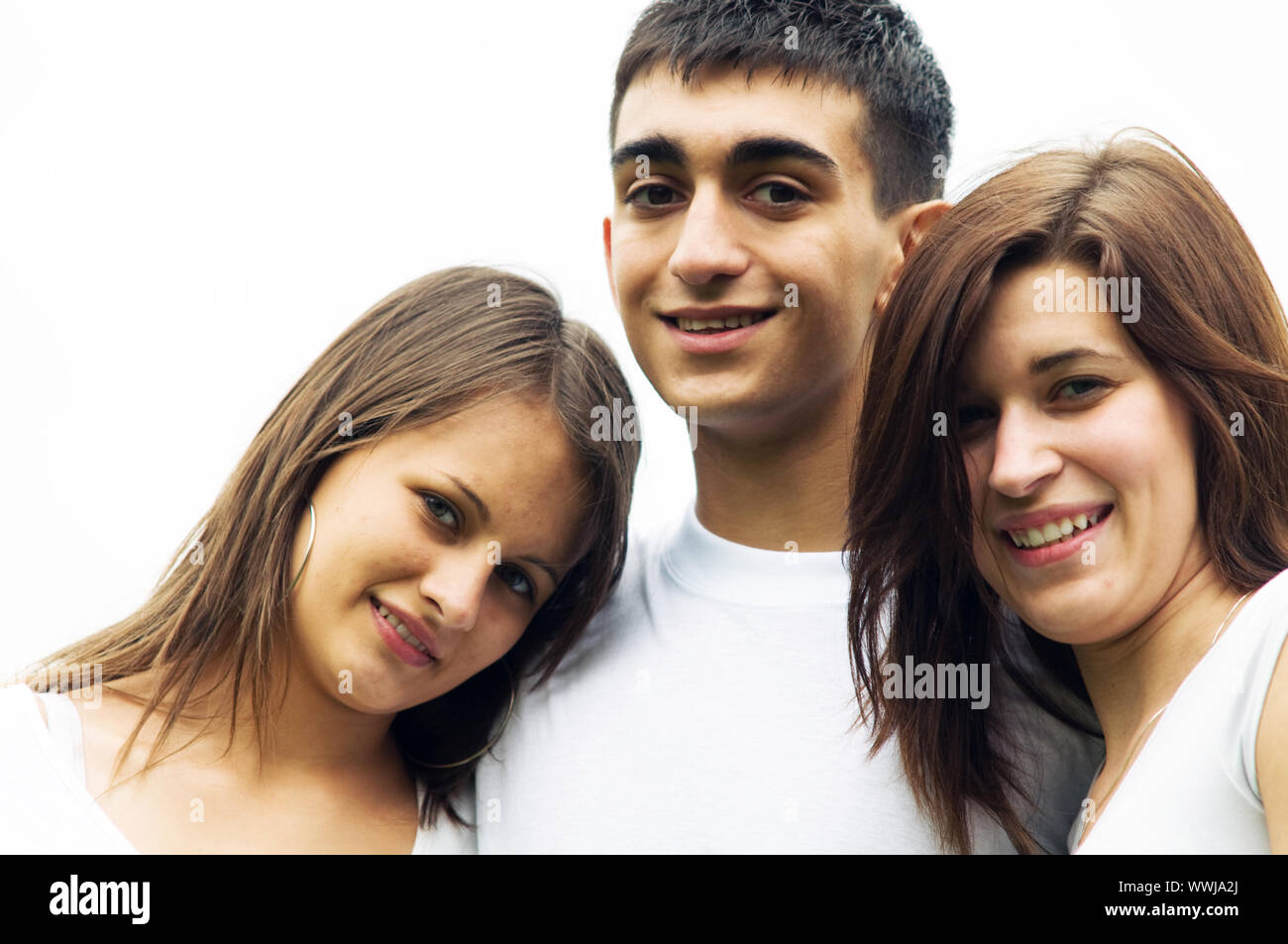 Three young happy friends standing together and smiling Stock Photo - Alamy