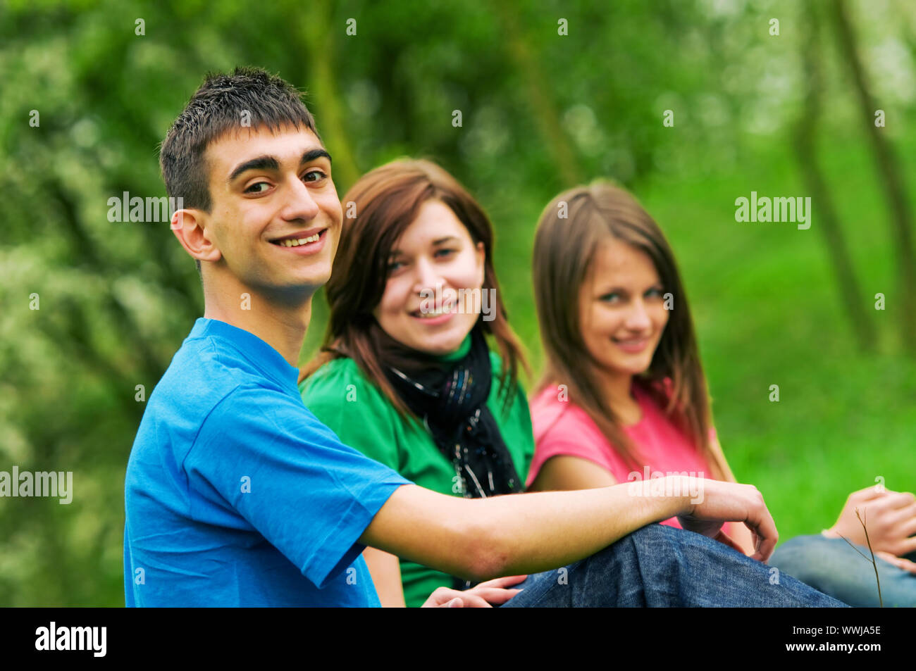 Three young happy friends lying together and smiling Stock Photo - Alamy