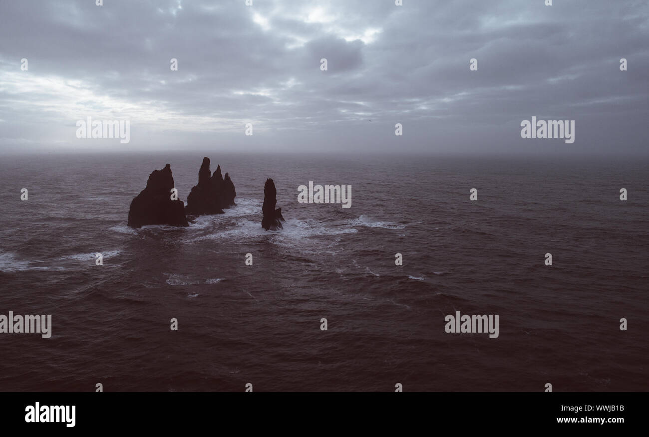 Black sand beach, and basaltic rocks in the ocean in Iceland Stock ...