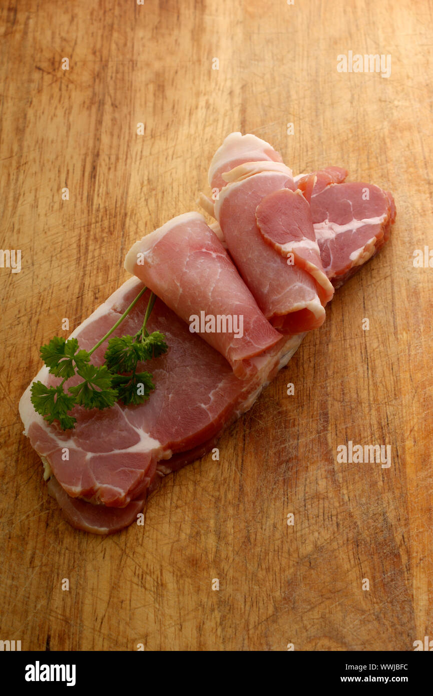 smoked bacon on a timber board with organic parsley Stock Photo - Alamy