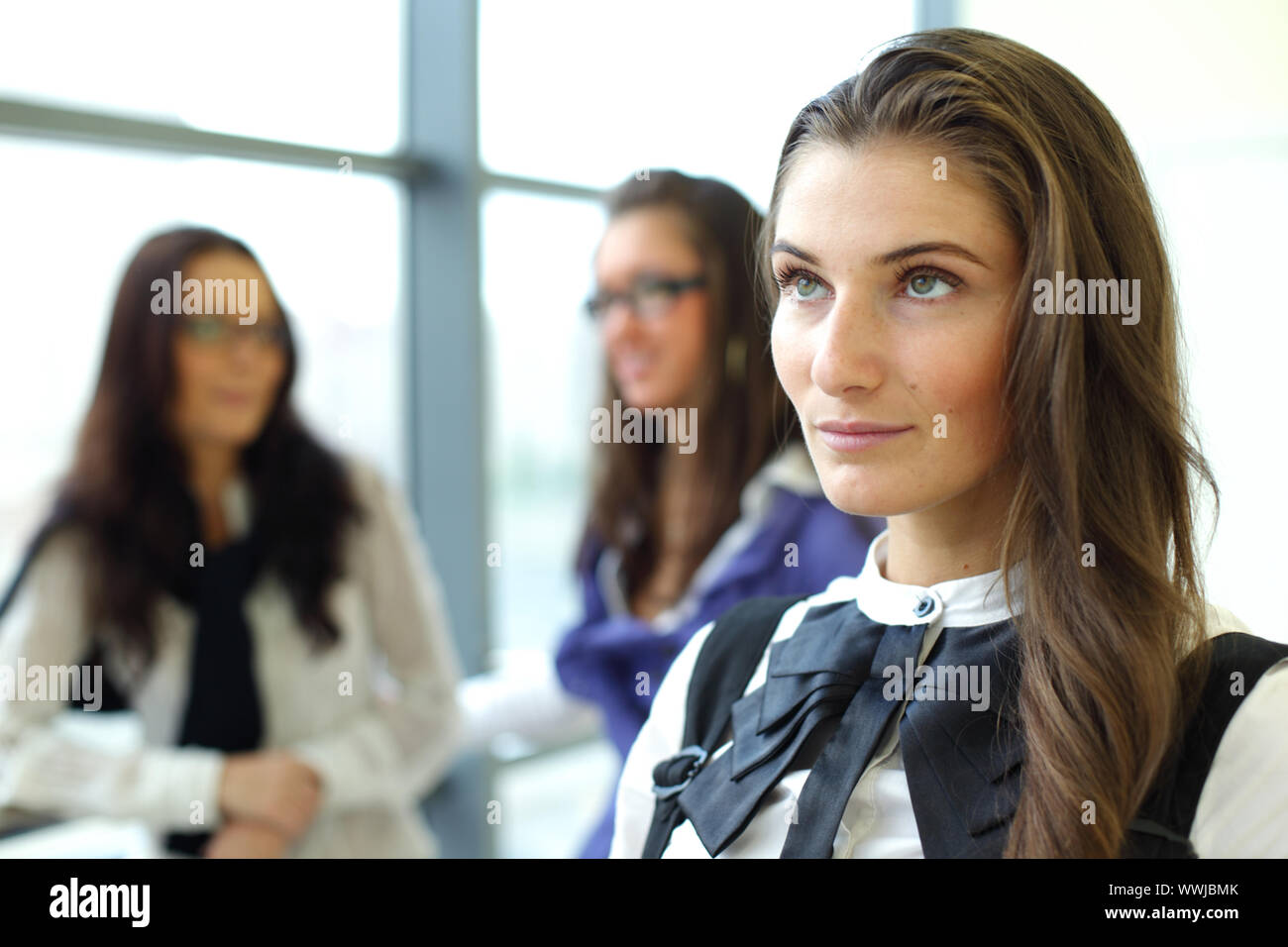 Student meeting smiley girl face on foreground Stock Photo - Alamy