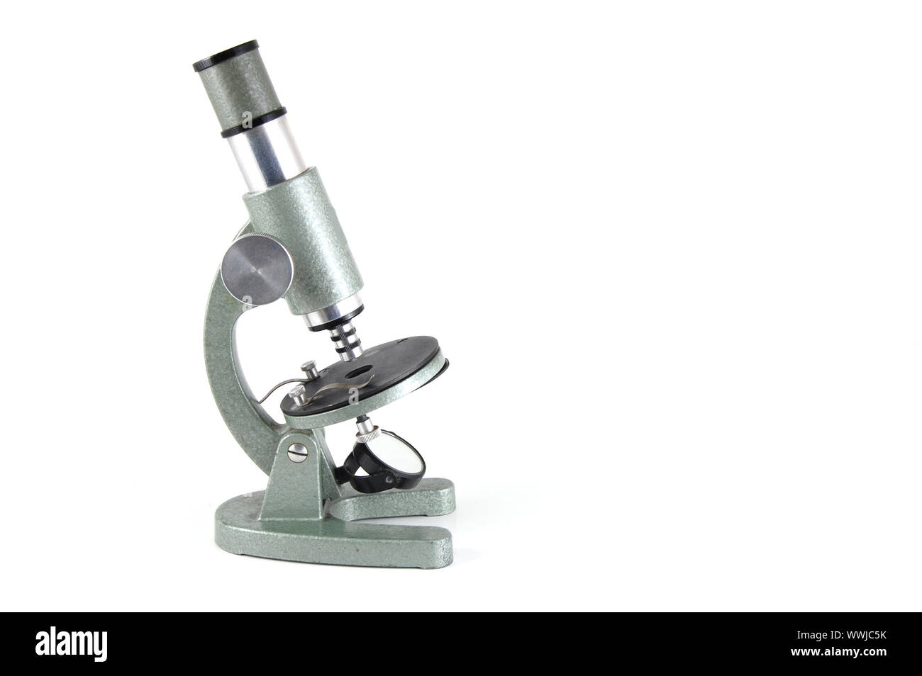 Old microscope isolated on a white background Stock Photo - Alamy