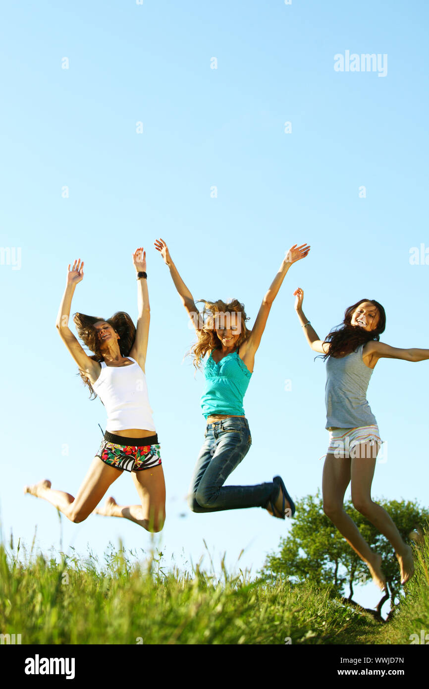 fun smile girlfriends jump to sky Stock Photo - Alamy