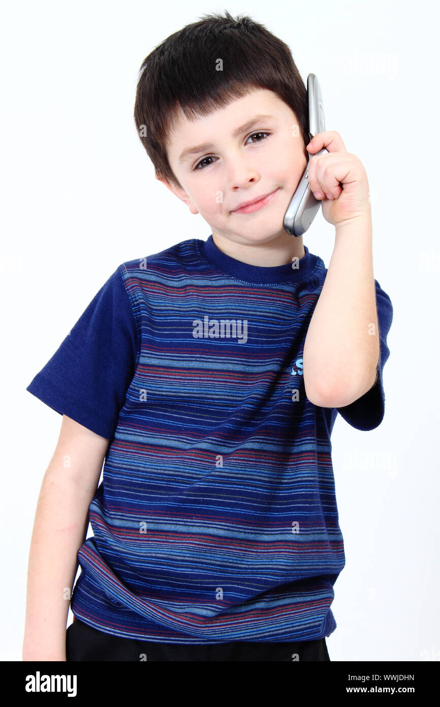 Small boy calling from mobile phone to friend on white background Stock ...