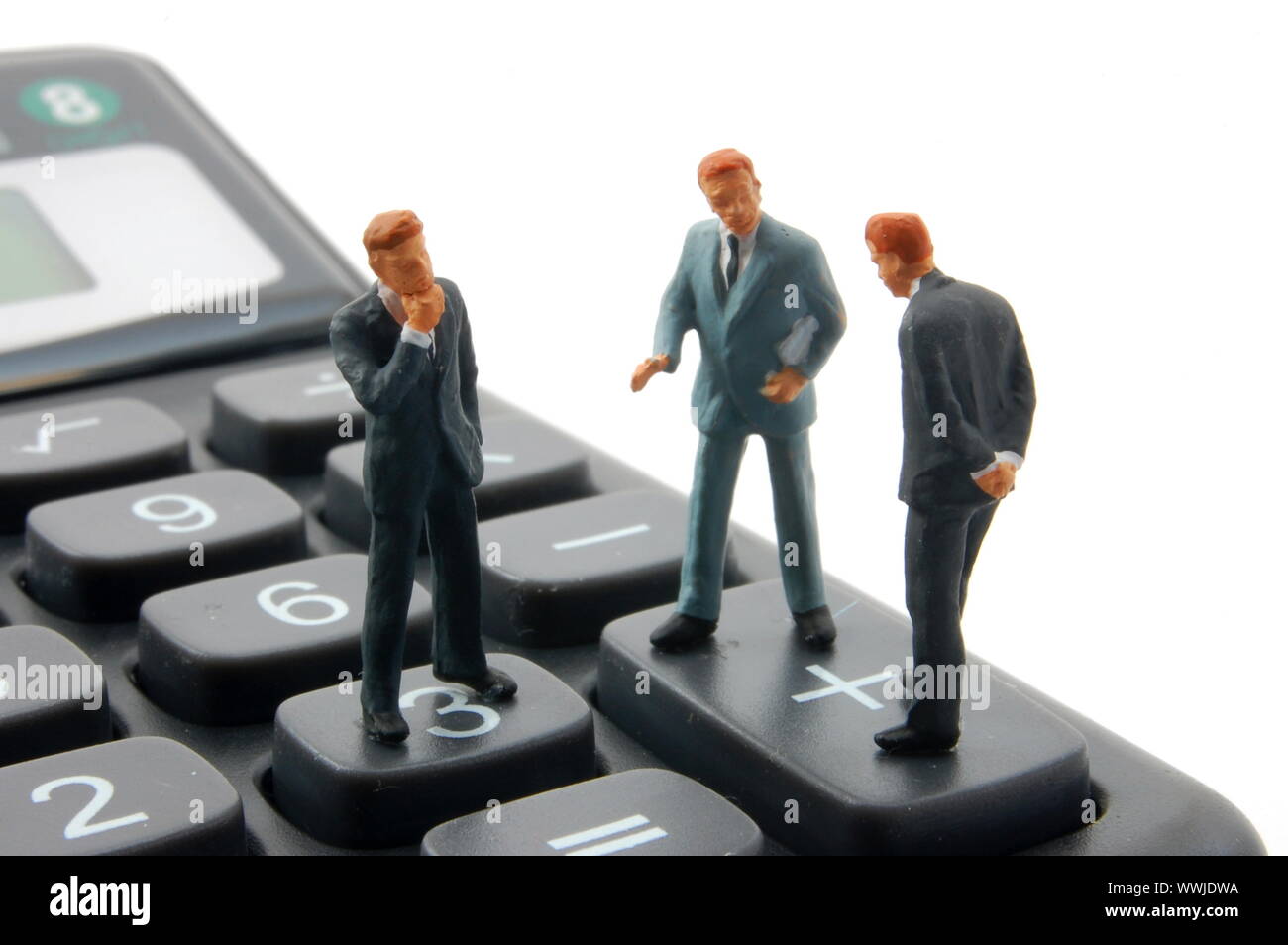 toy business man on calculator isolated on white background Stock Photo ...