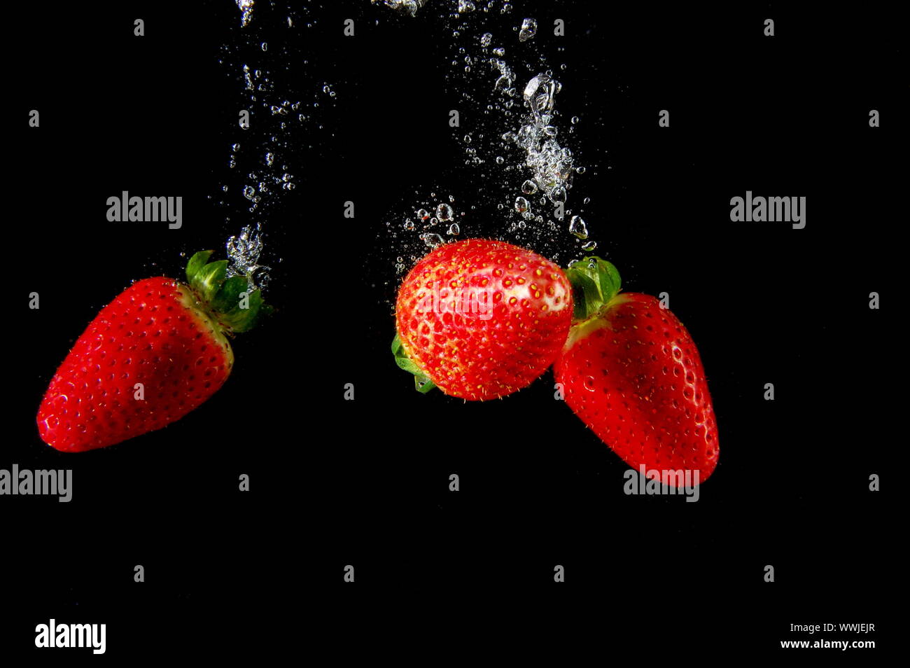 strawberry splashing in water in white background Stock Photo - Alamy