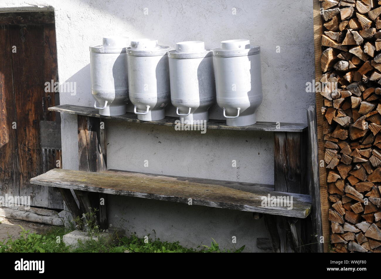Milk cans at an alpine hut Stock Photo - Alamy