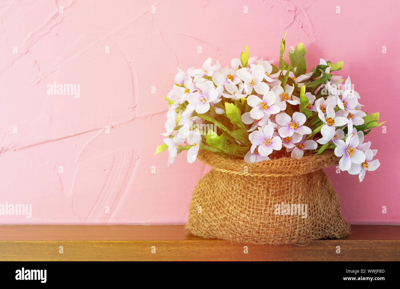 Artificial flower on sunset, pink background Stock Photo - Alamy