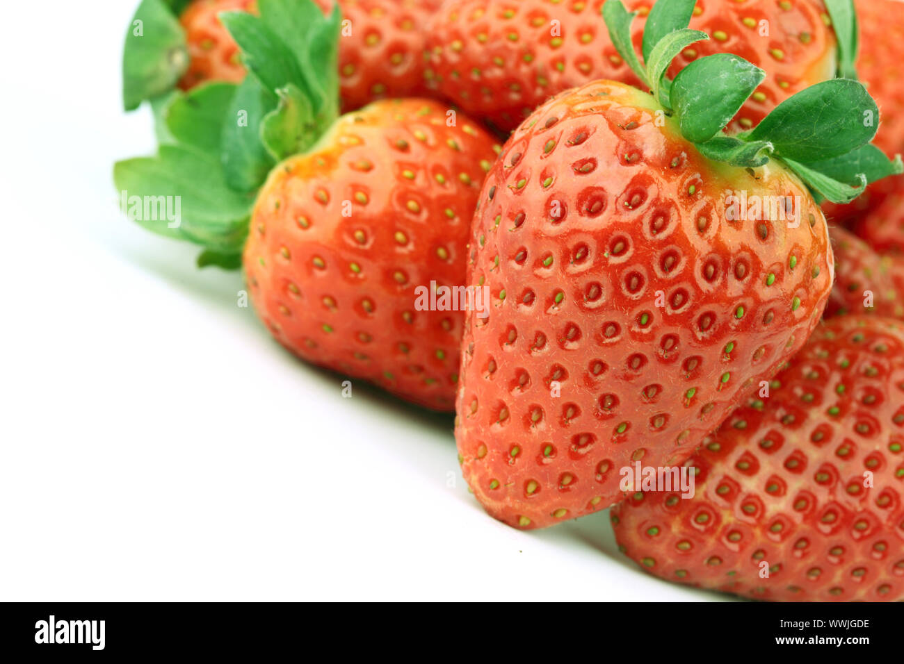 strawberry pile on white background Stock Photo - Alamy