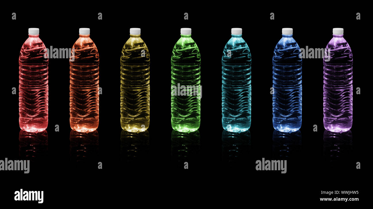 Seven bottles of drinking water colors of the rainbow on a black ...