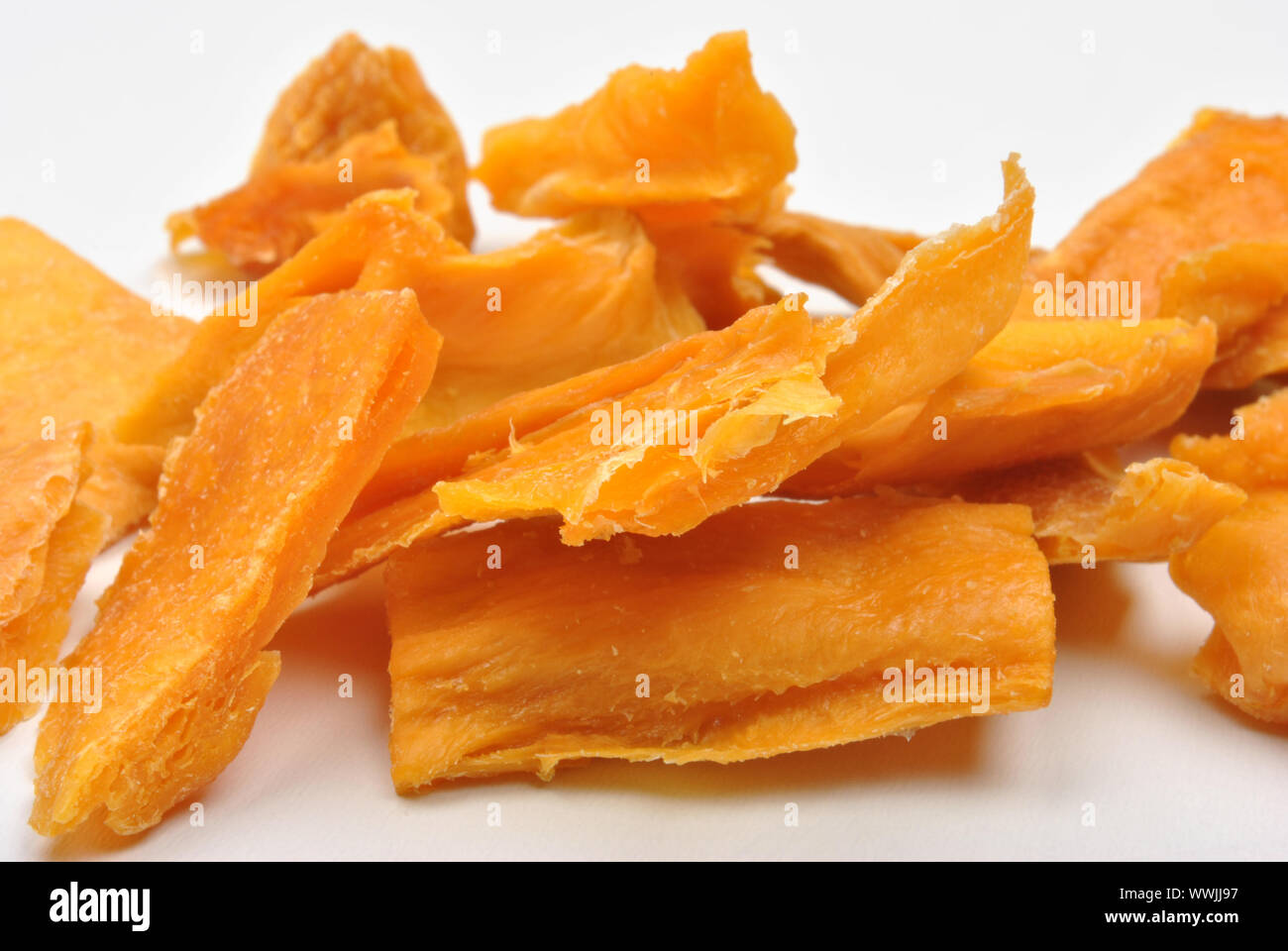 natural dried organic mango and a white background Stock Photo - Alamy