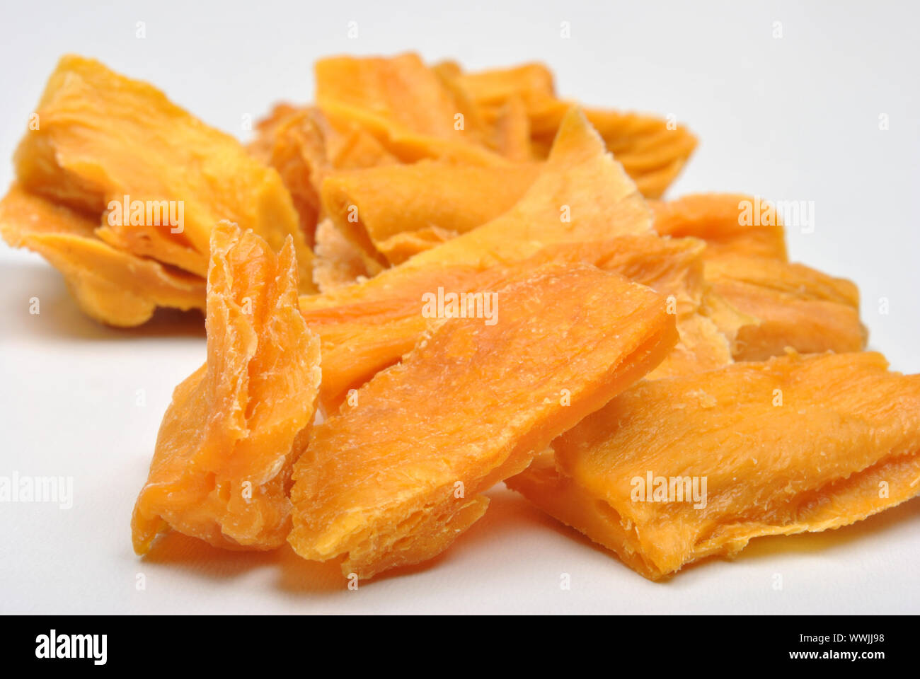 natural dried organic mango and a white background Stock Photo - Alamy