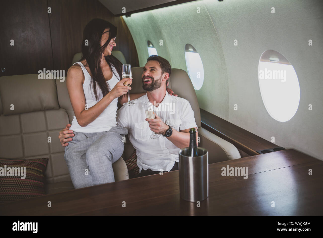 Couple on vacation, flying on their private jet Stock Photo - Alamy