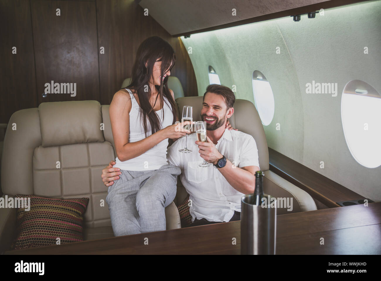 Couple on vacation, flying on their private jet Stock Photo - Alamy