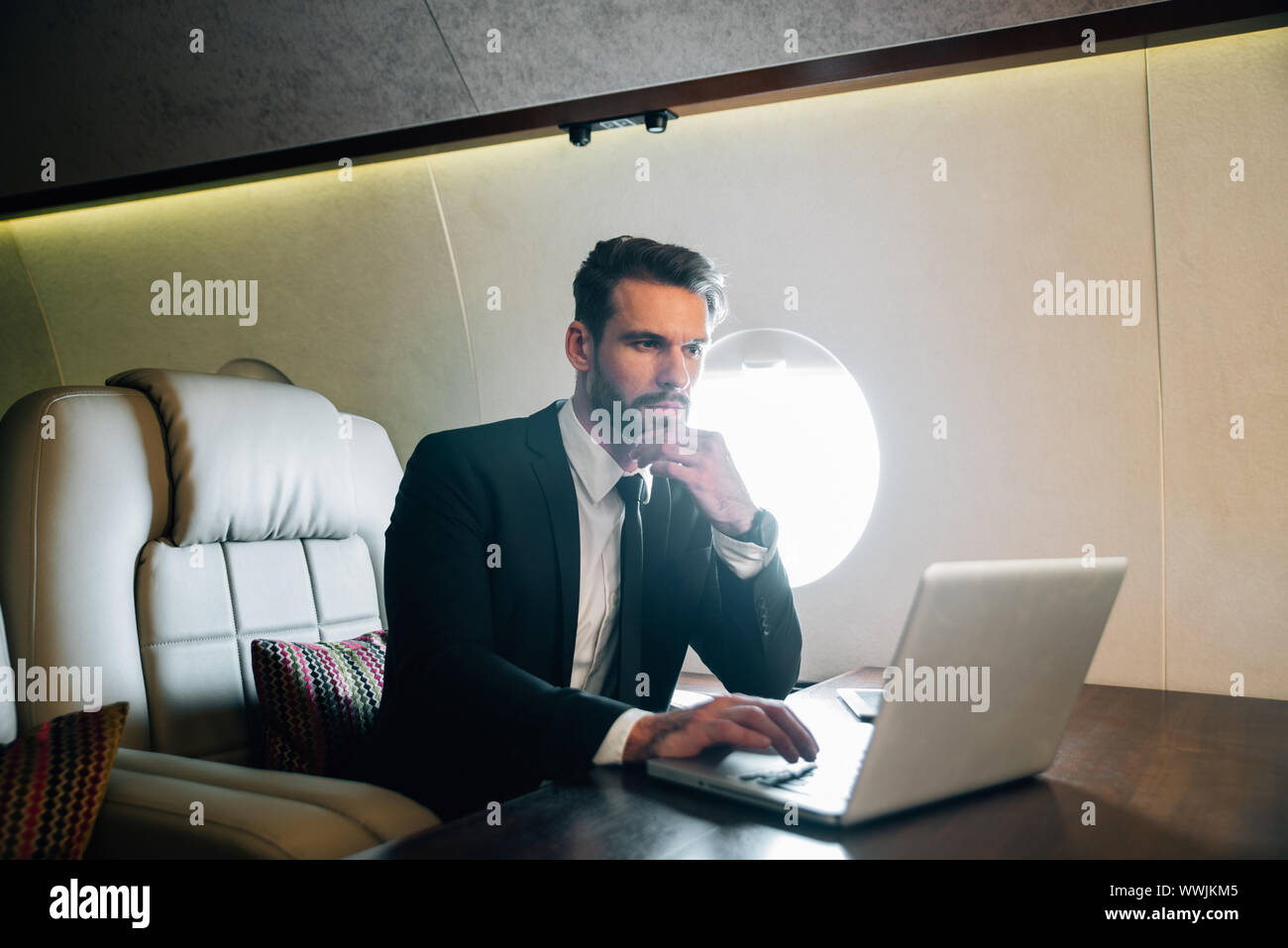 Businessman flying on his private jet Stock Photo - Alamy