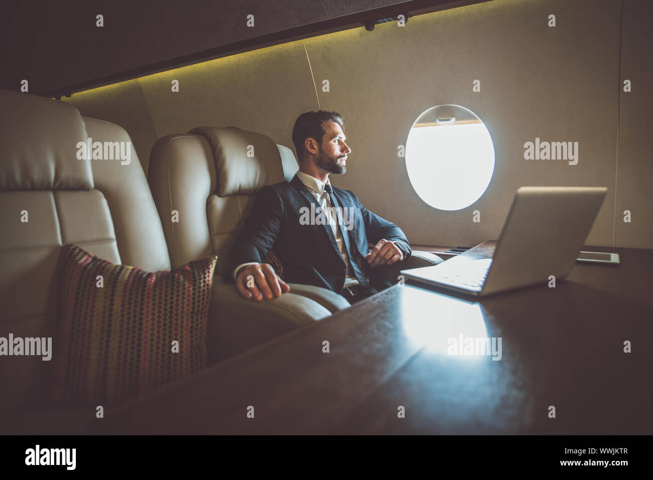 Businessman flying on his private jet Stock Photo - Alamy