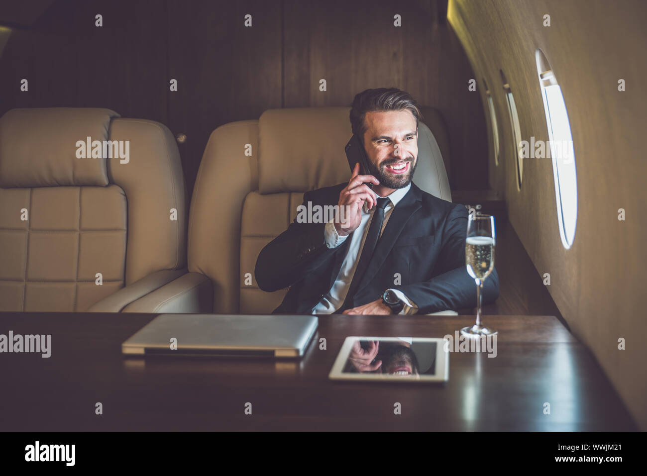 Businessman flying on his private jet Stock Photo - Alamy